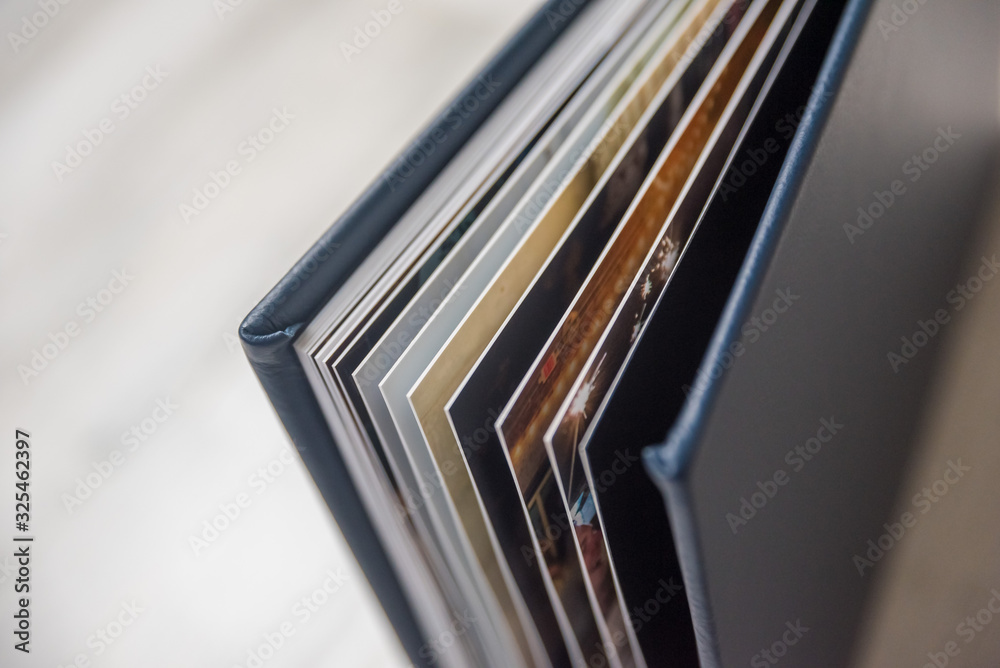 Side view close up of thick and rigid wedding album pages in a book ...