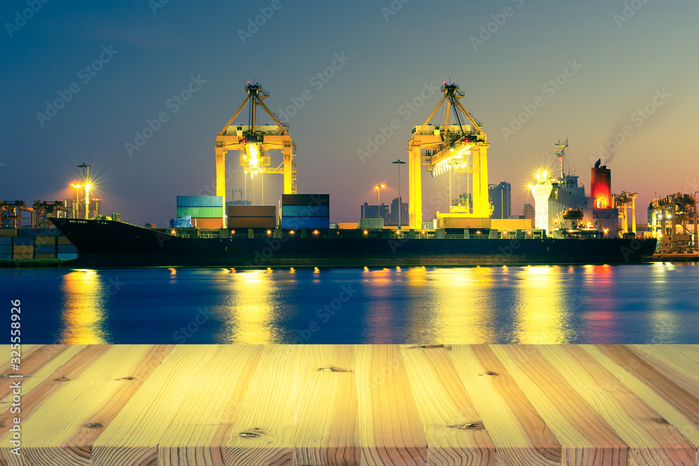 Gantry crane loading and unloading cargo container from cargo ship at ...