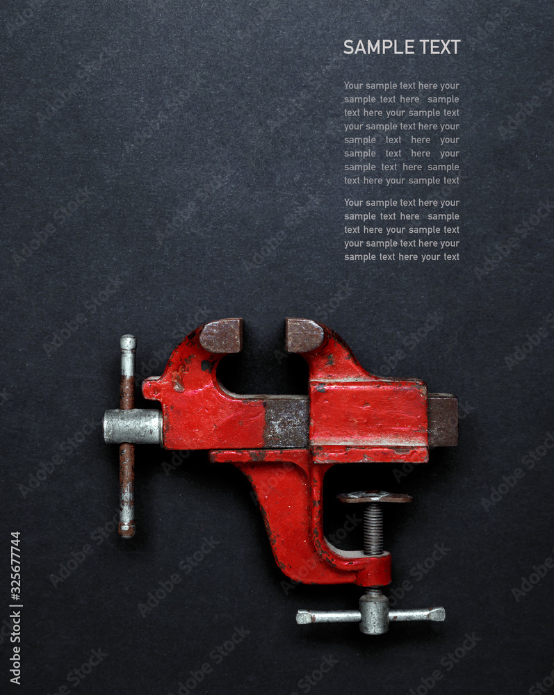 Metalwork tool - red vintage mechanical hand vise clamp on grey ...