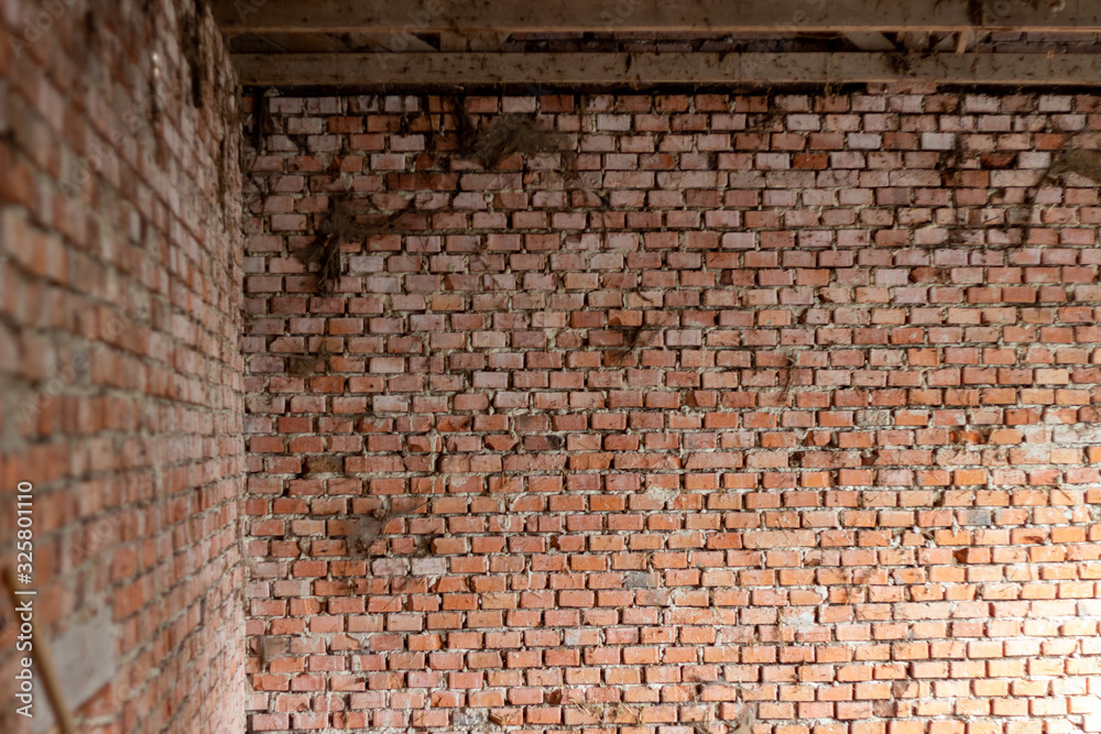 Detail of an ancient red brick wall slightly bleached with salt. The ...