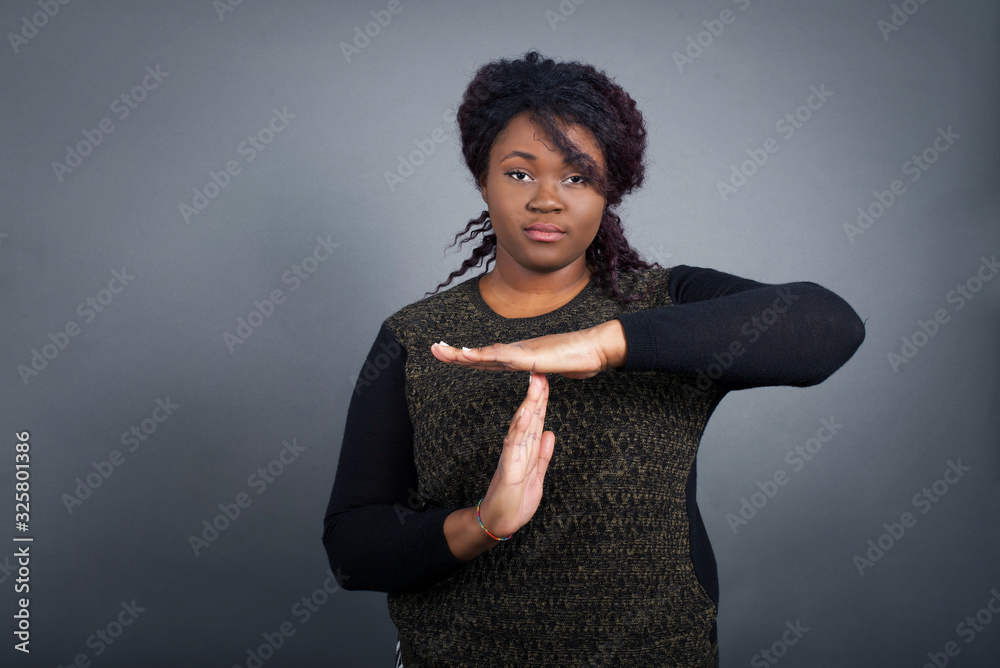 Young pretty African American girl tired and bored, making a timeout ...