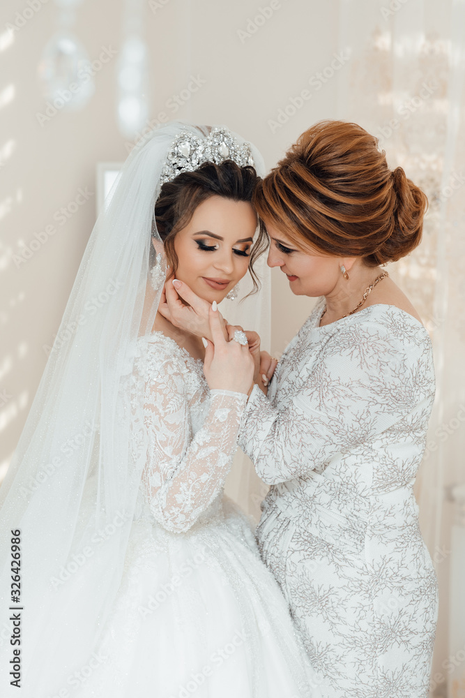 Daughter who became the bride gently embraces her mother. Mother of the ...