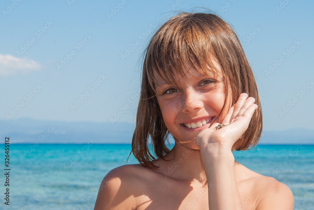 Young girl looking for seashells at the beach Stock Photo | Adobe Stock