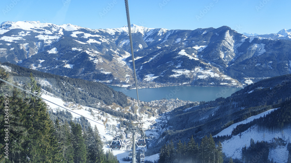 Aerial view of tourist resort with winter lake, snowed evergreen forest ...
