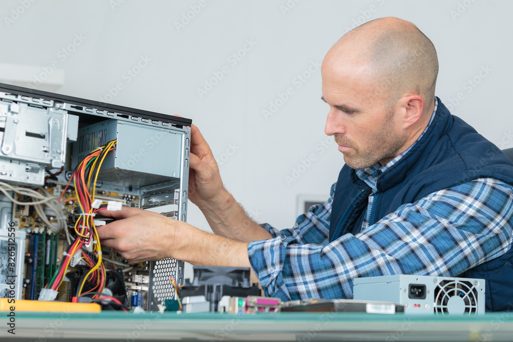 man fixing an old desktop computer Stock Photo | Adobe Stock