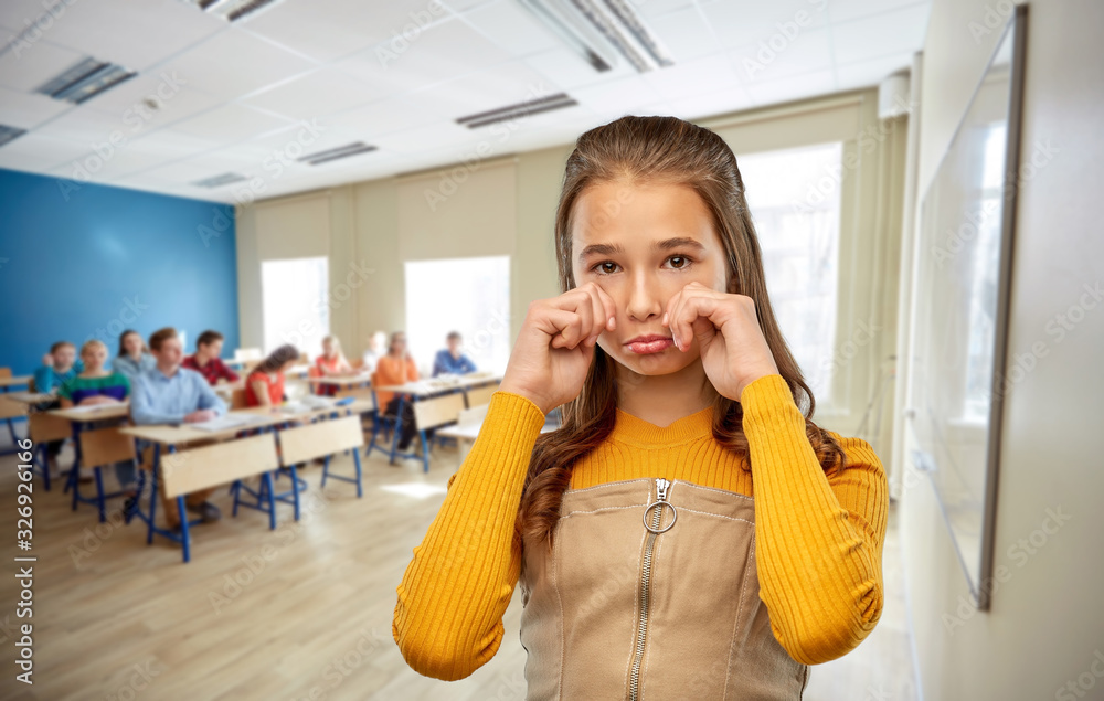 bullying, school and people concept - unhappy crying teenage student girl over classroom ...