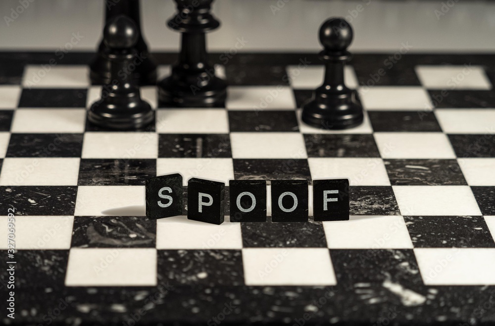 The concept of Spoof represented by black and white letter tiles on a ...