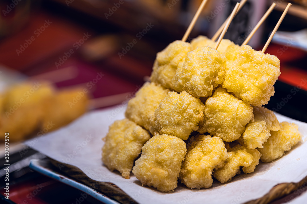 Display of tempura snack with breading crust on skewer in traditional ...