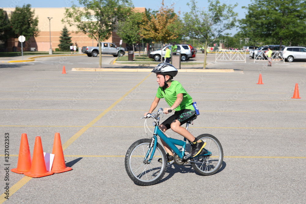 Young boy riding his bike during a triathlon going around cones Stock ...