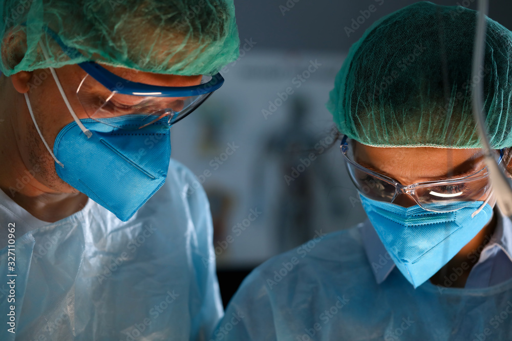 Surgeon and anastasiologist in uniform look down. Surgical ...