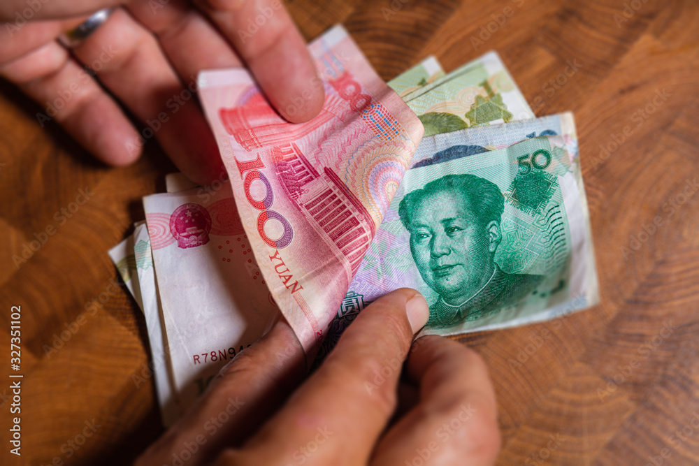 Foto de Stock Male hand shows Renminbi or Chinese yuan or abbreviated ...