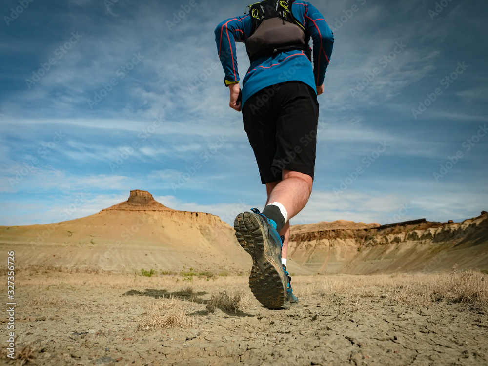 Foto de Stock Runner athlete with backpack running on the wild trail at ...