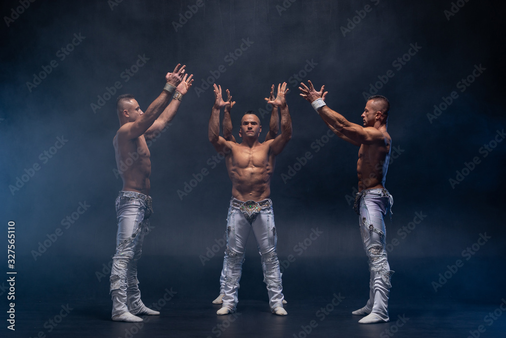 Four muscular gothic man standing shirtless on black background ...