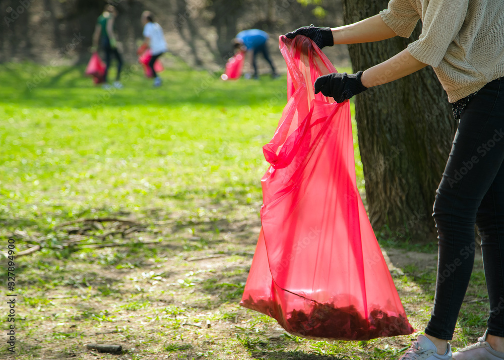 Man and woman volunteer wearing picking up trash and plastic waste in ...