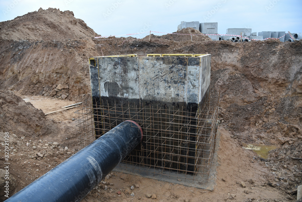 Laying of underground storm sewer pipes in ditch. Installation of water ...