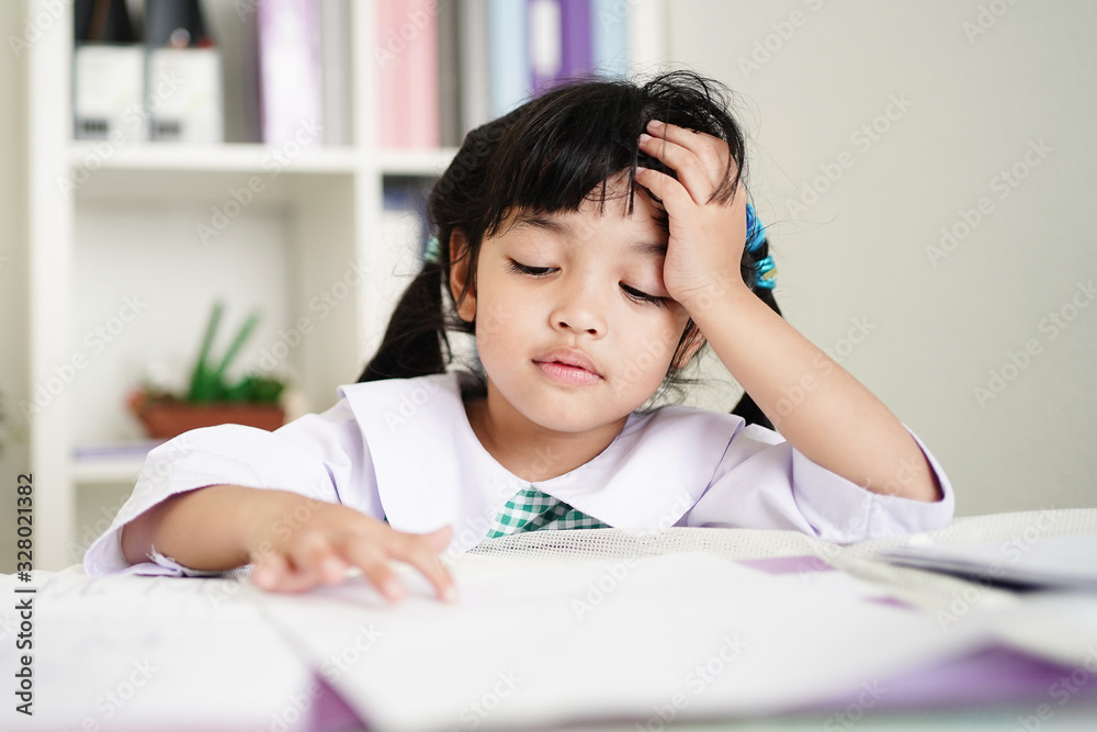 Little child girl concentrate and focusing to the homework for ...