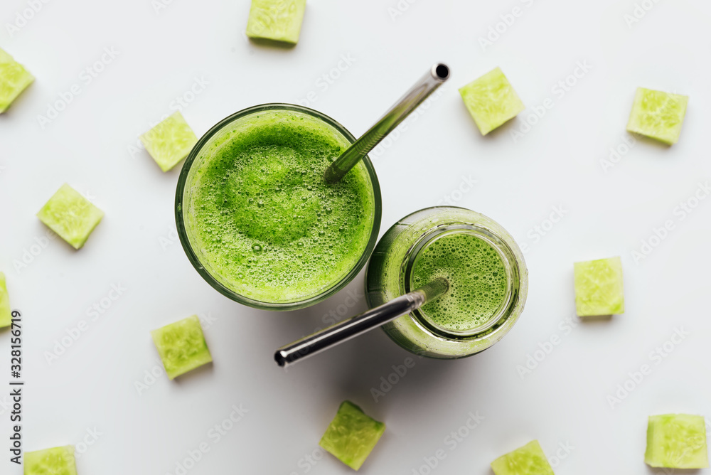 Cucumber vegan smoothie in many glasses, nutrient hydrating green juice ...
