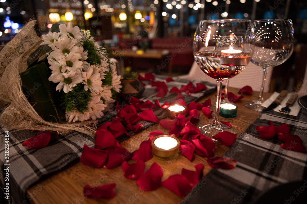 elegance wedding proposal table with rose petals and wine glasses Stock ...
