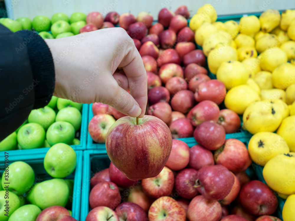 Choosing the right apple on the market Stock Photo | Adobe Stock