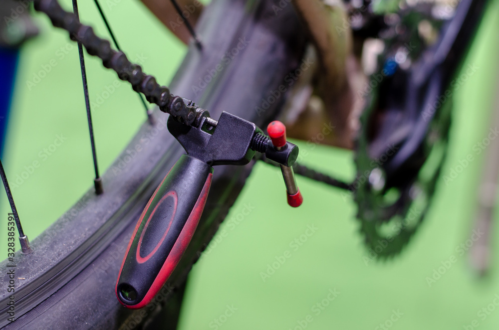 Repair mountain bike in the workshop. Replacing an old rusty chain with ...