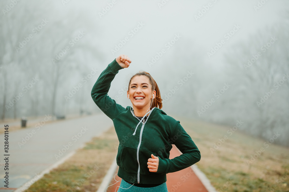 Beautiful female athlete with ponytail celebrating new personal best ...