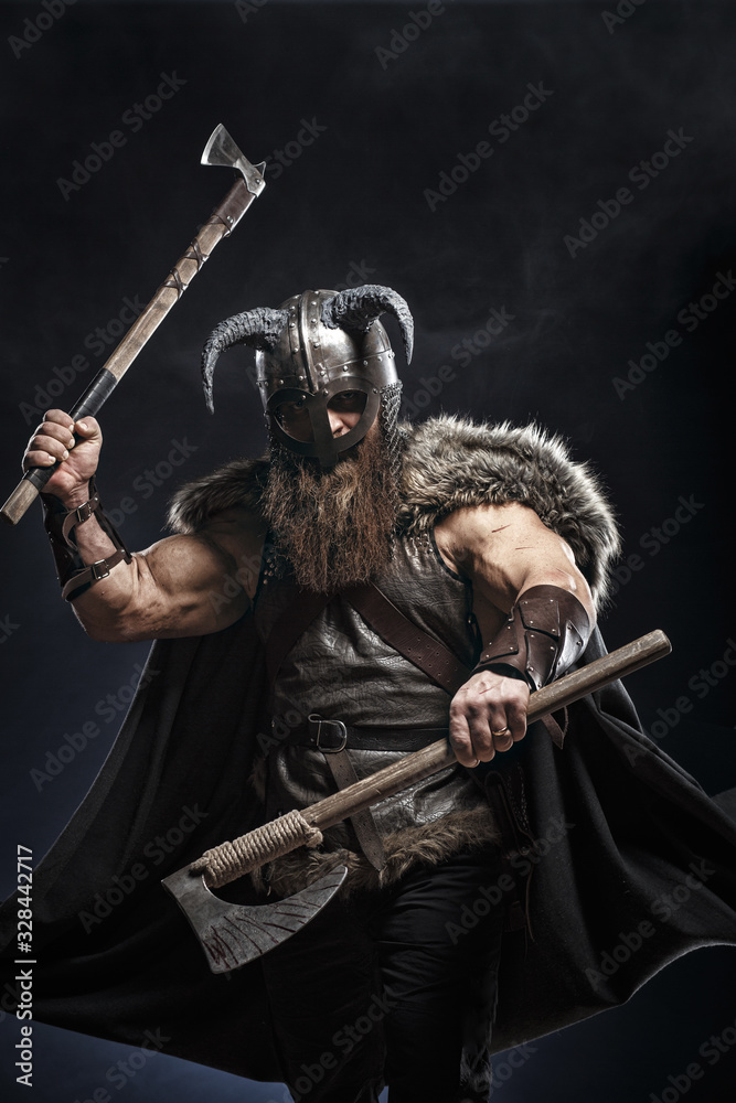 Medieval warrior berserk Viking with axes attacks enemy. Concept ...