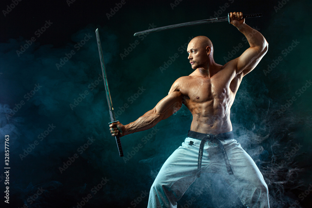 Stock-Foto „Karate fighter on black background with smoke. Shirtless ...