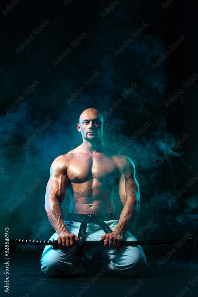 Karate fighter on black background with smoke. Shirtless man samurai ...