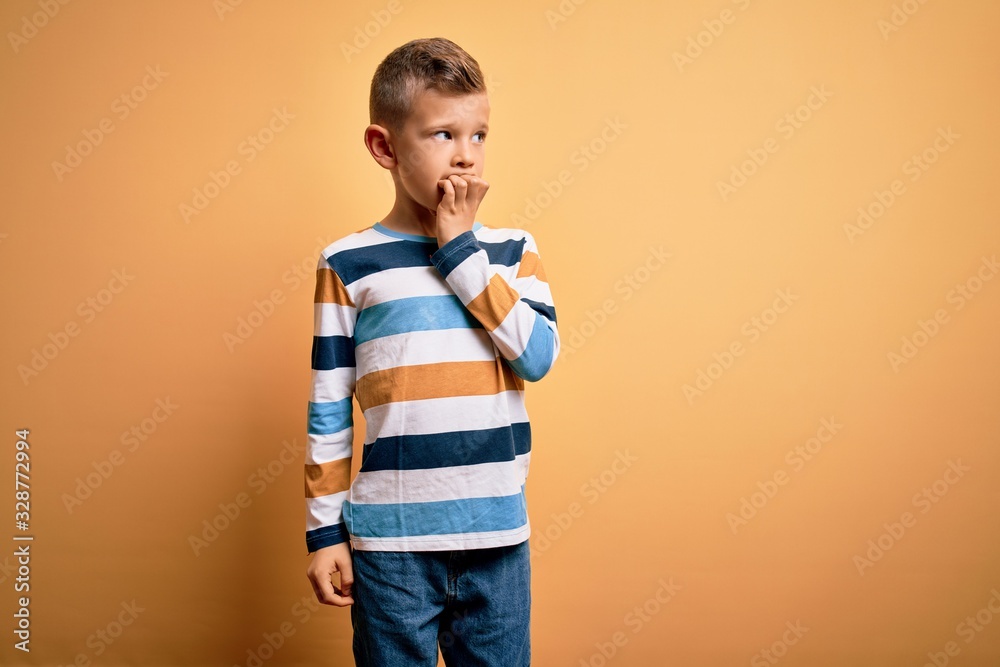 Young little caucasian kid with blue eyes wearing colorful striped ...