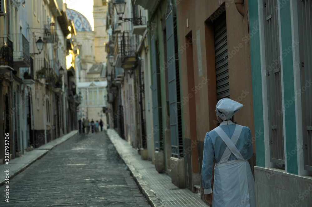 Woman wearing the outfit that nurses wore in ancient times. Nurse in a ...