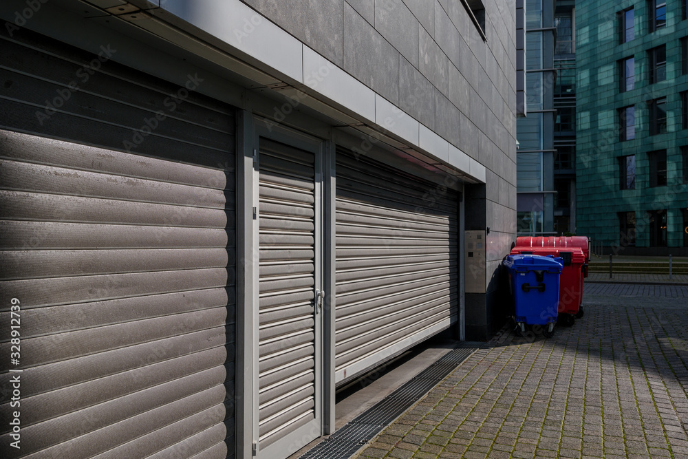 View of metal roller shutter doors and metal door at service area of ...
