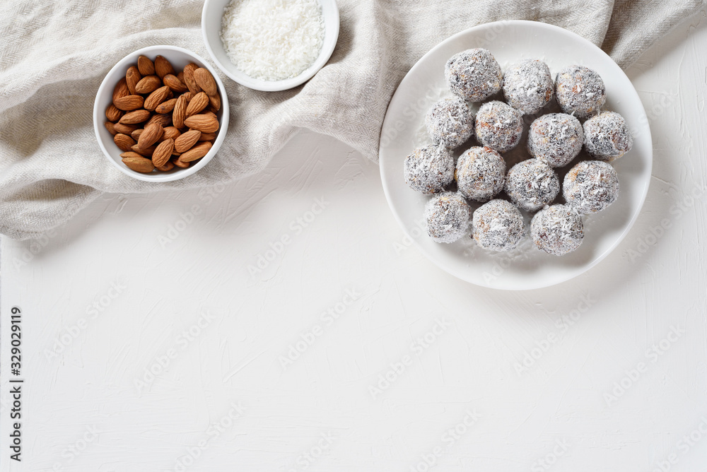 Vegan food energy balls with prunes, almond and coconut. White ...