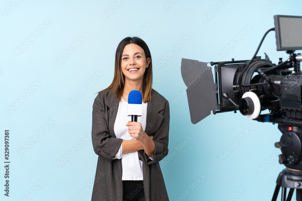 Reporter woman holding a microphone and reporting news over isolated ...