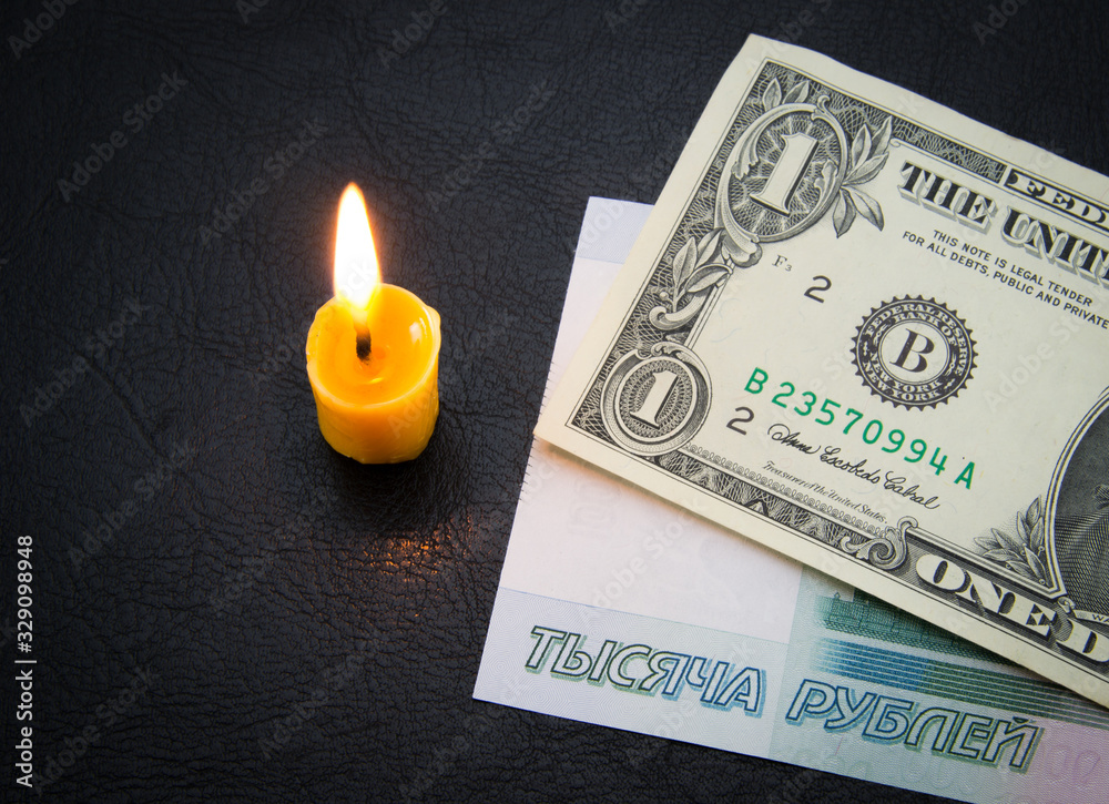 One US dollar and one thousand Russian rubles on a black, isolated ...