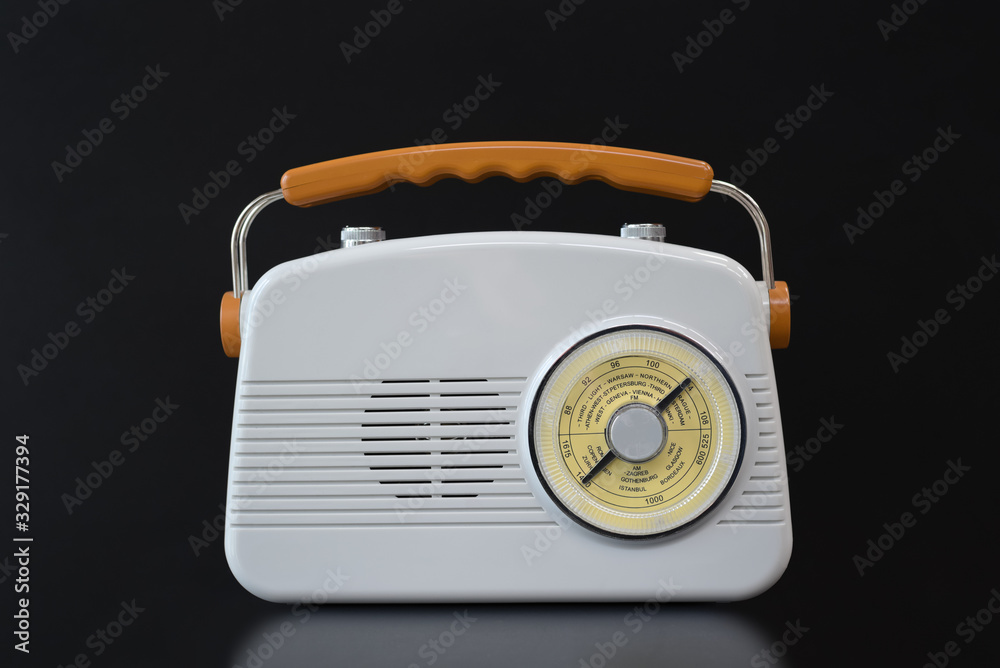 vintage designed radio in the center on the black background, old ...