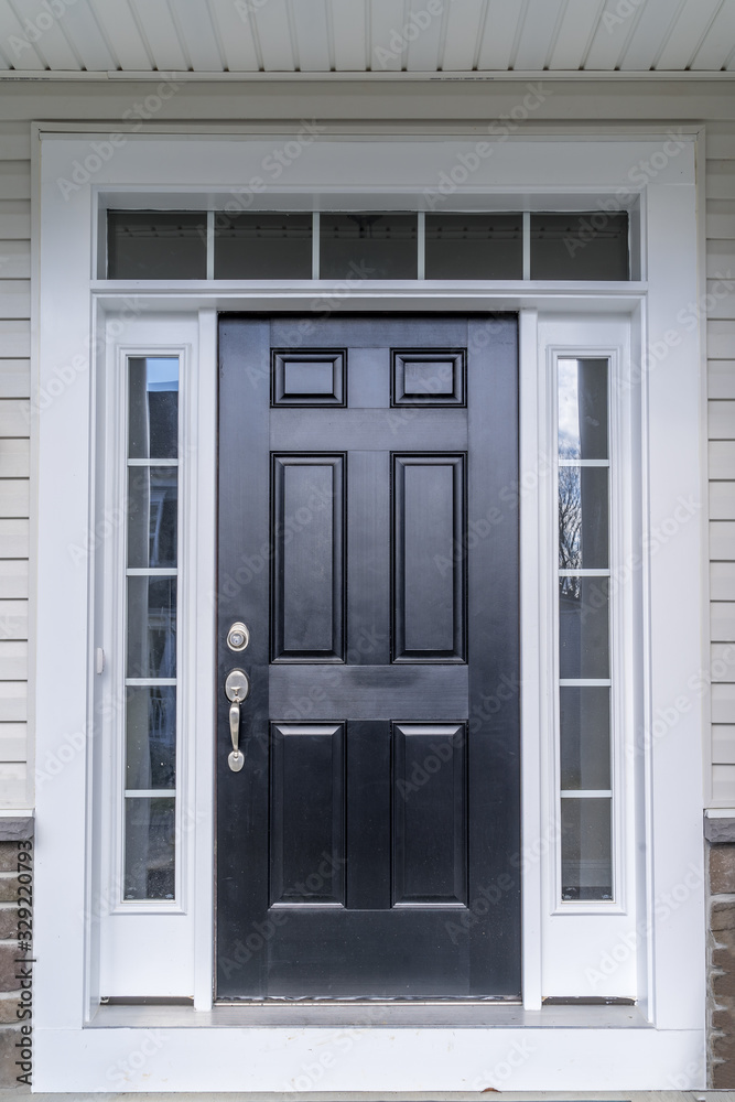 Classic fiberglass prehung black front door, raised panels, white frame, sill, jamb separating ...