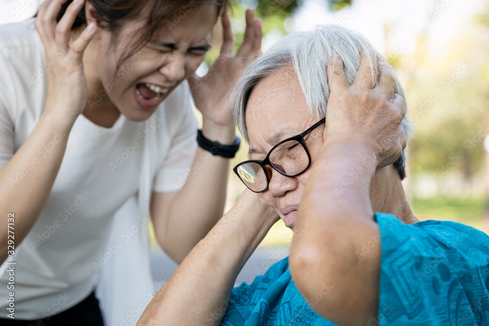Angry asian daughter shouting scolding at her senior mother about fussy ...