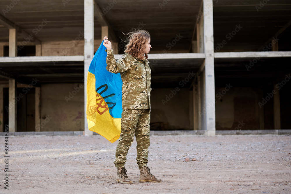 Young curly blond military woman, wearing ukrainian army uniform ...