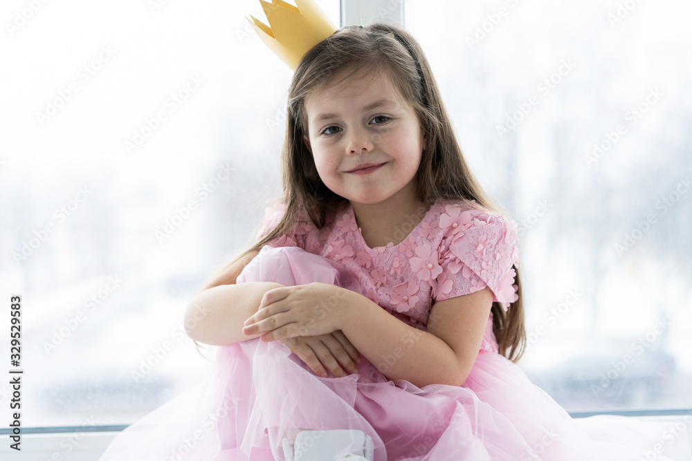 Cute little girl in a princess costume. Pretty child preparing for a ...