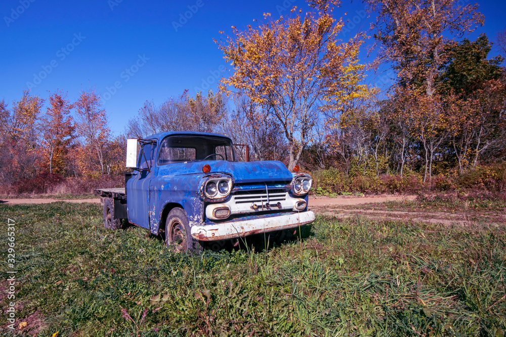 Tired Old Truck in the Field Tired old work truck is parked in a ...