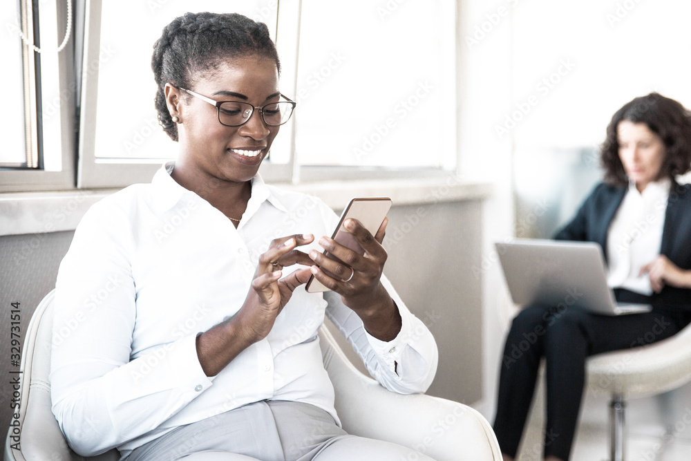 Happy female office worker sharing content on social media. Diverse ...