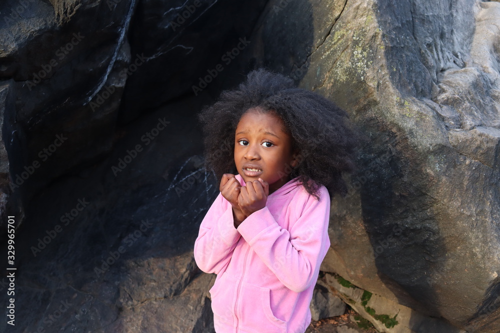 Scared Kid in rock cave background Stock Photo | Adobe Stock