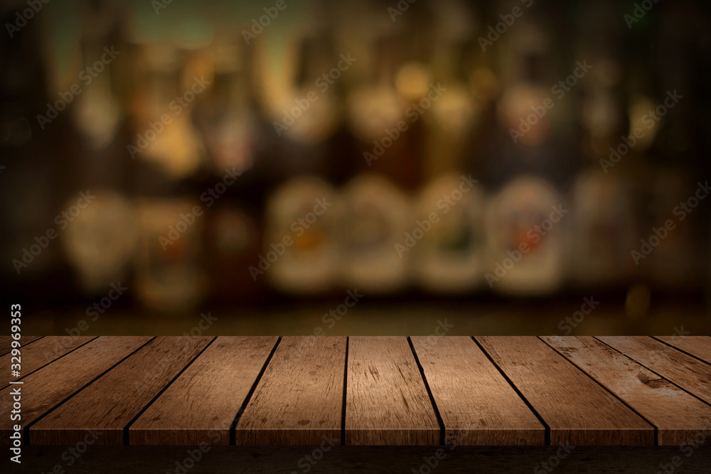 Wooden table with a view of blurred beverages bar bottle background ...