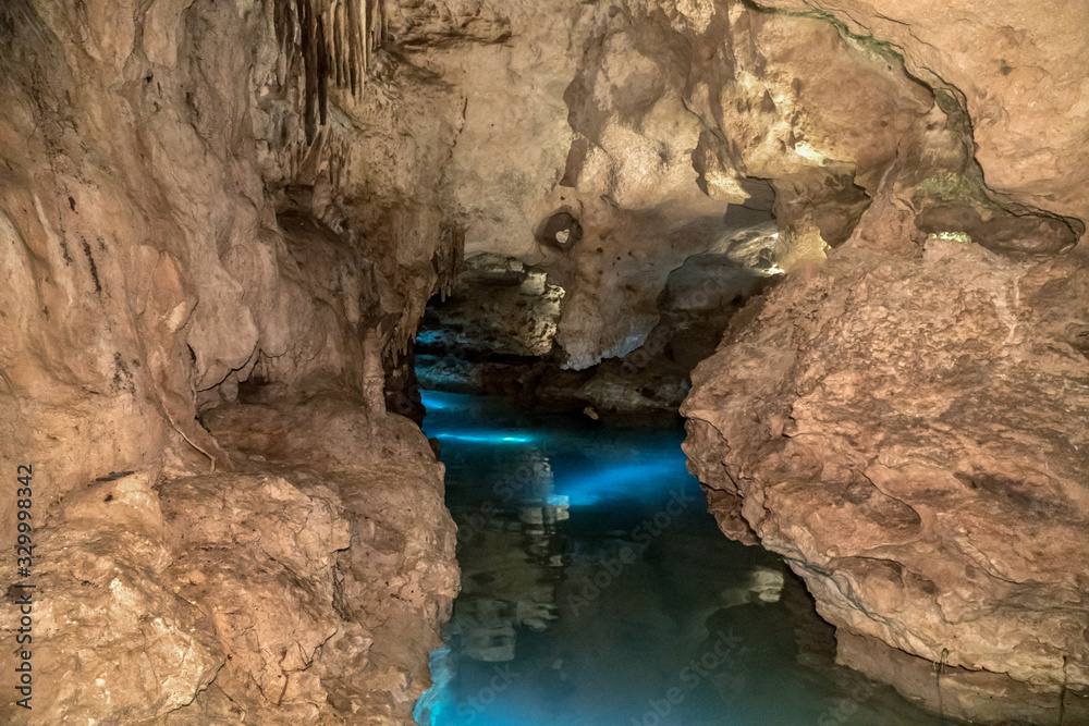 Amazing underground limestone caves. Blue river is under light. Mexican ...