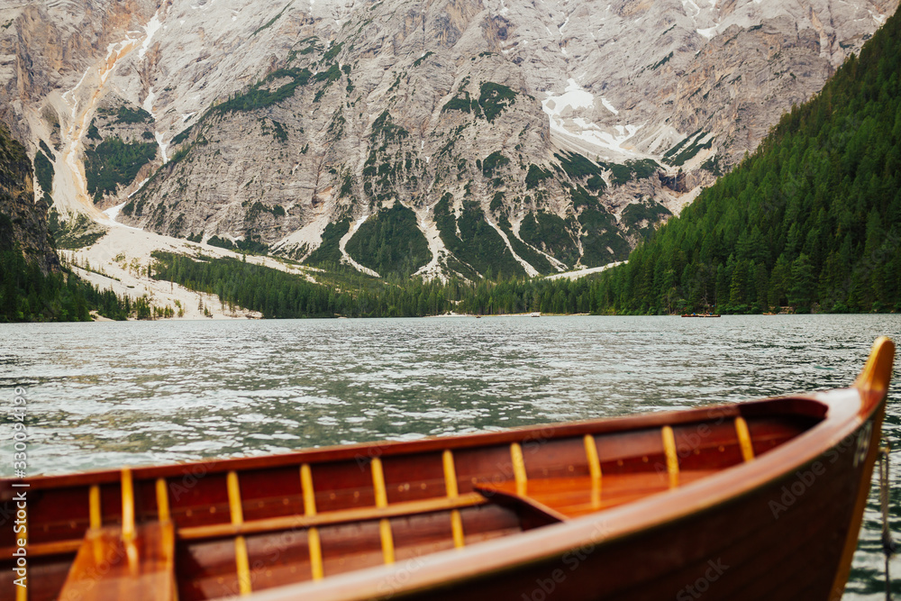 Empty wooden boat on water in Lago di Braies (Braies lake, Pragser ...