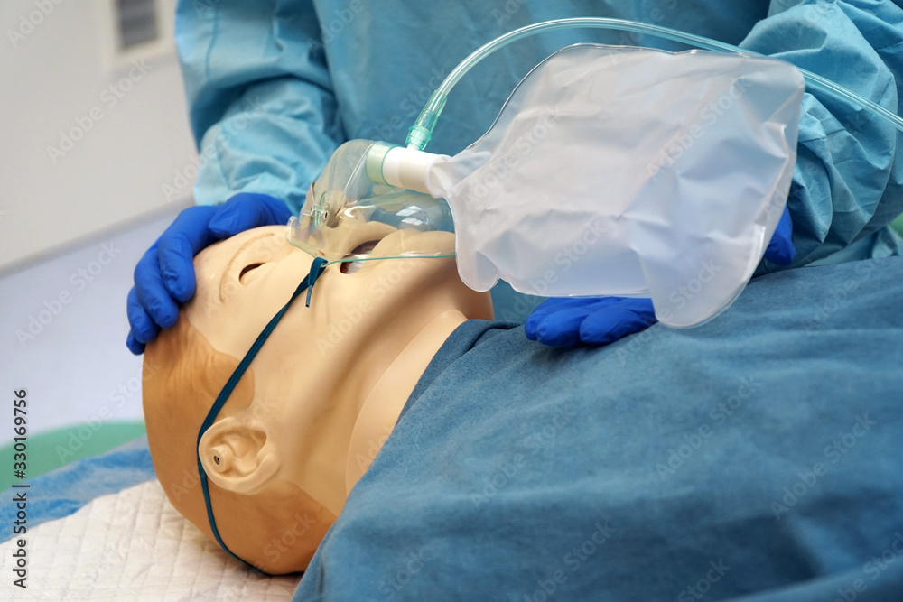 Doctor shows the use of a non-rebreather oxygen mask using a medical ...