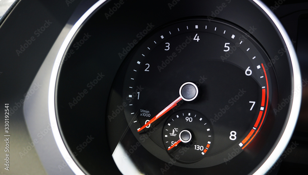 Tachometer with integrated temperature sensor with two red arrows. Both ...