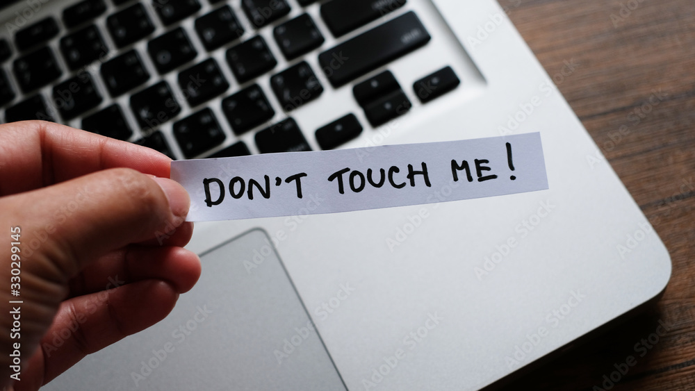 Don't Touch ME! message concept written post it on laptop keyboard ...