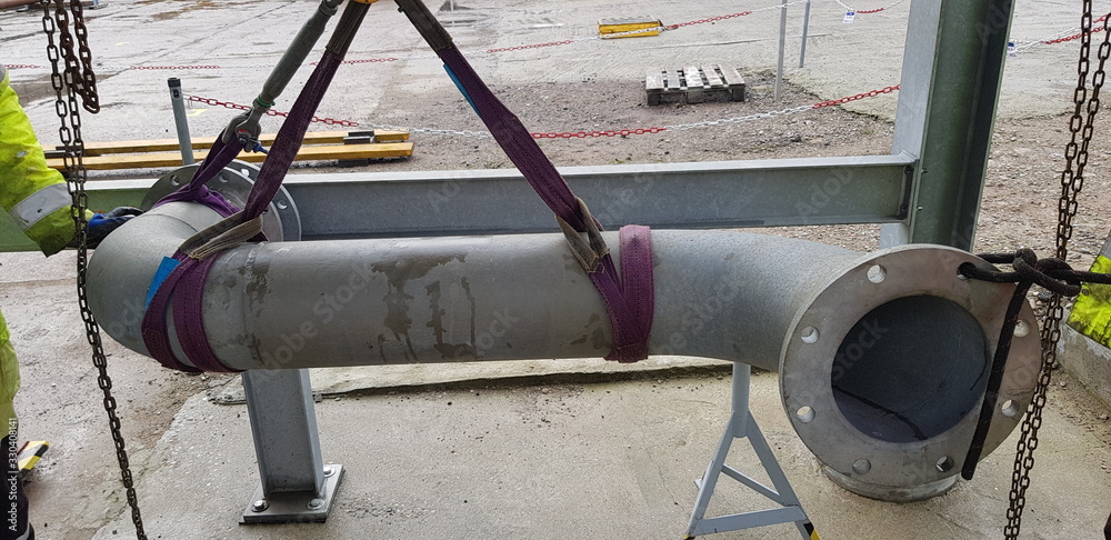 riggers move the pipe using two chain blocks Stock Photo | Adobe Stock