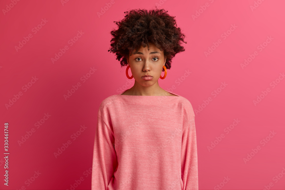Photo Stock Young distressed curly woman has sad expression, pity face ...